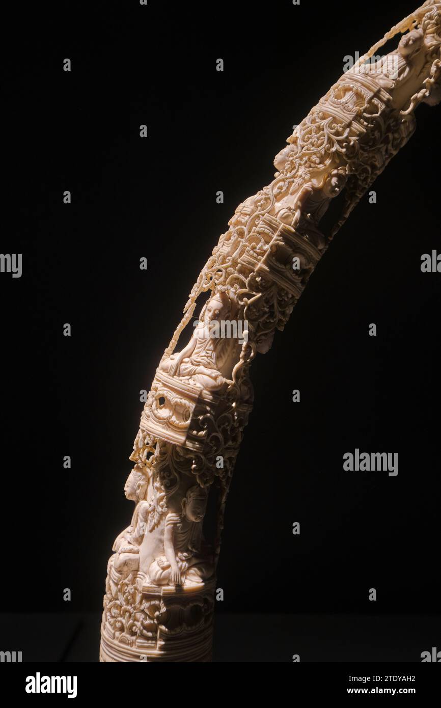 A detail in a display of an intricately carved ivory elephant tusk ...