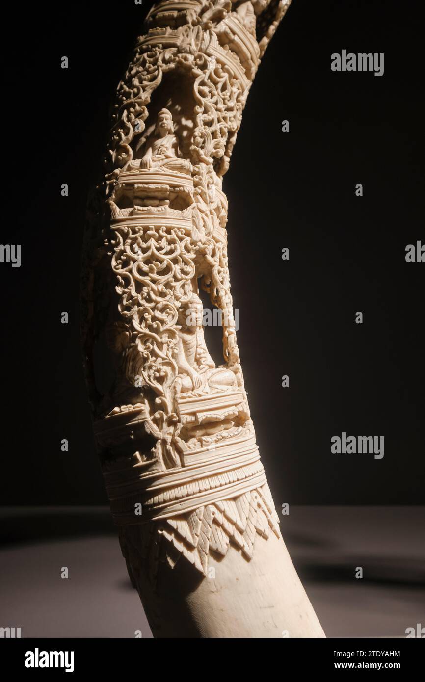 A detail in a display of an intricately carved ivory elephant tusk ...