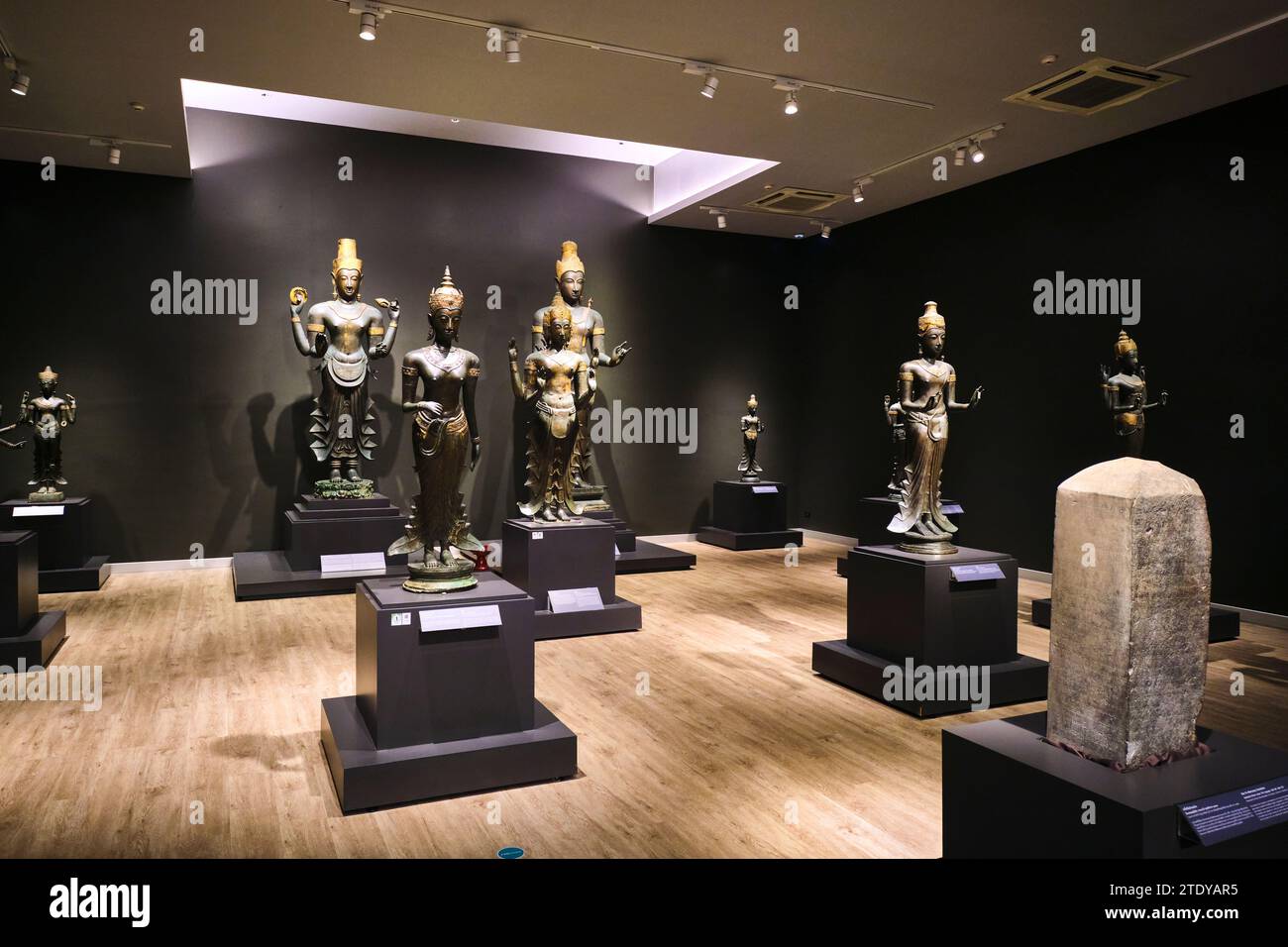 A display of many bronze, standing Buddha statues. Inside the Praphat ...