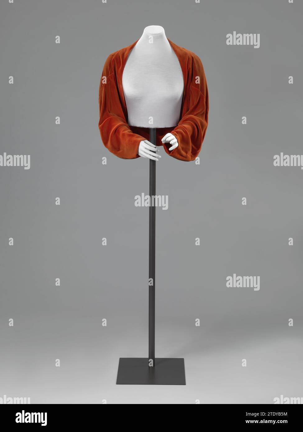 Short, blushed jacket of orange red sides velvet with long sleeves and ...