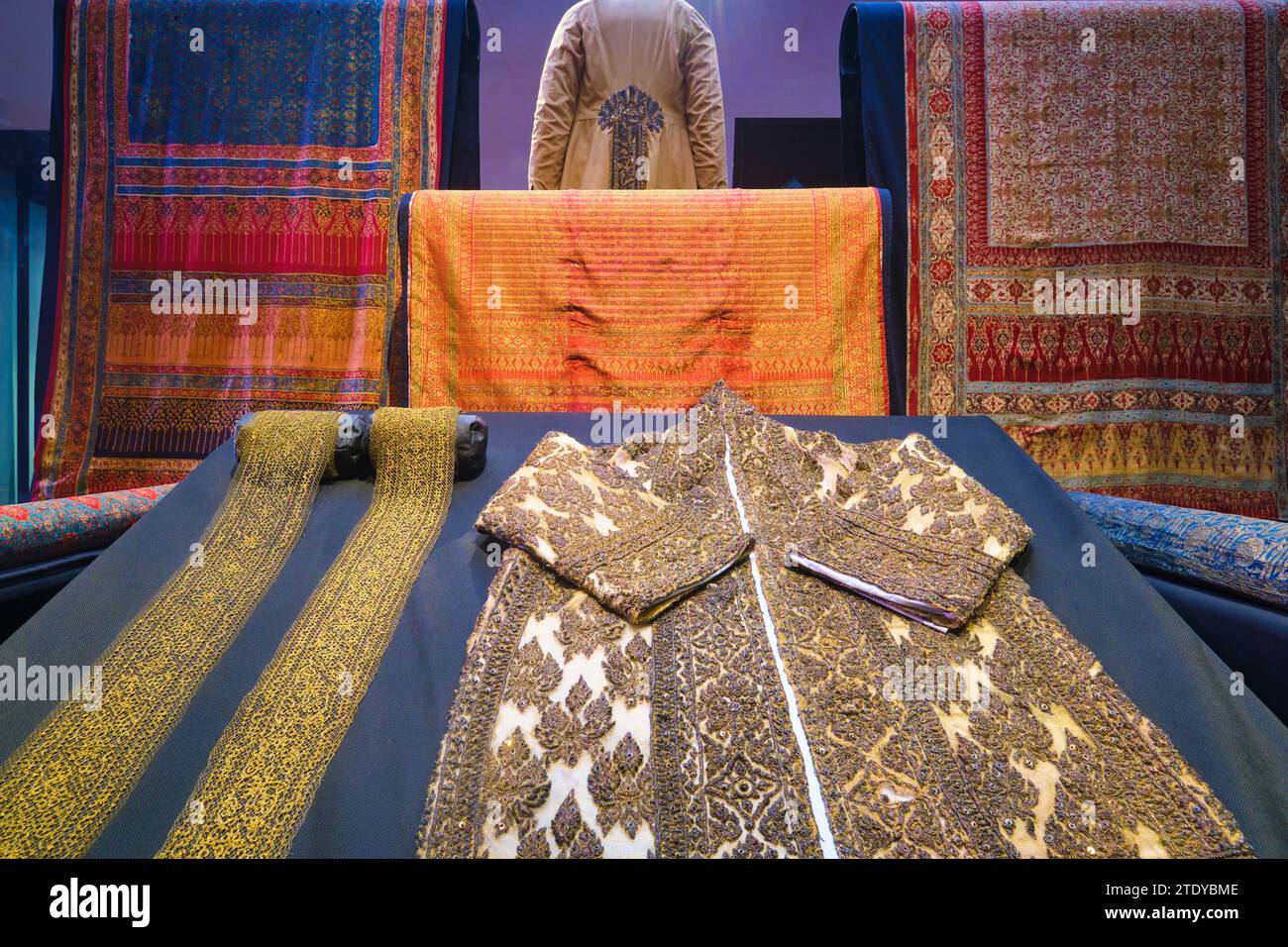 A display of a rich, fancy, gold and white royal robe and other fine ...