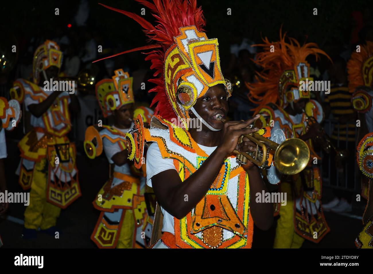 People celebrating in colorful costumes and dancing to music at the ...
