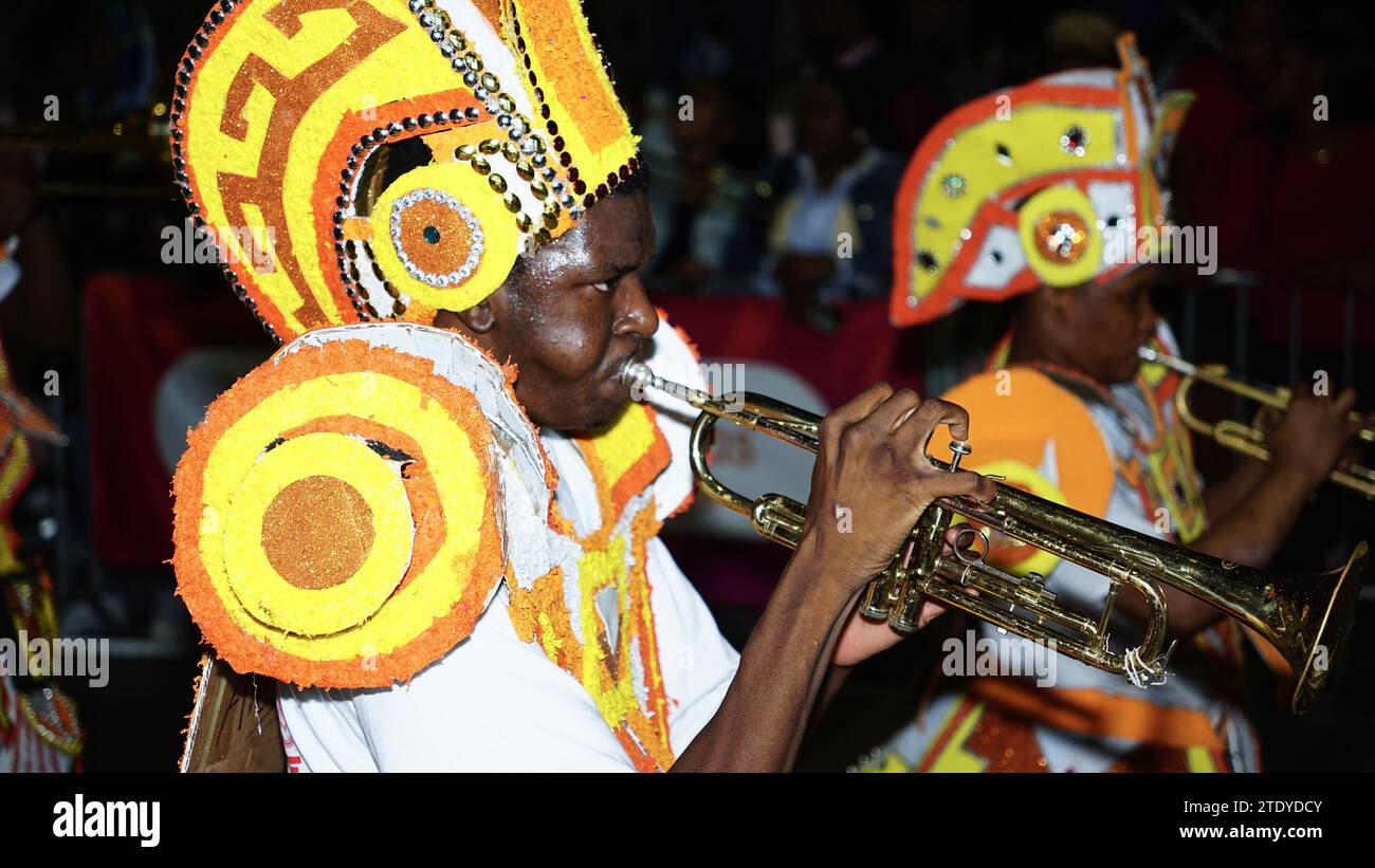 People celebrating in colorful costumes and dancing to music at the ...