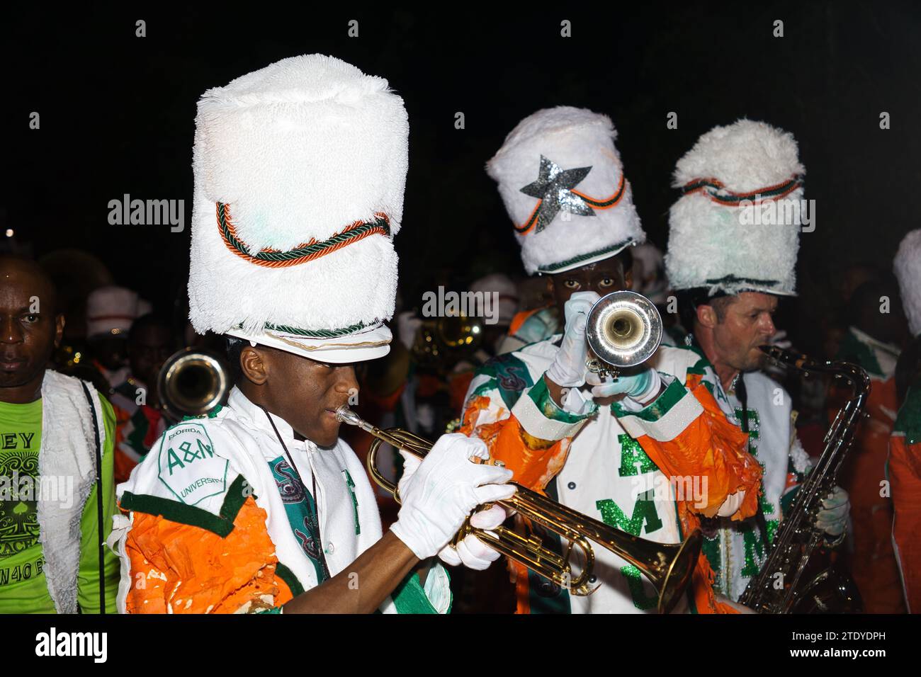 People celebrating in colorful costumes and dancing to music at the ...