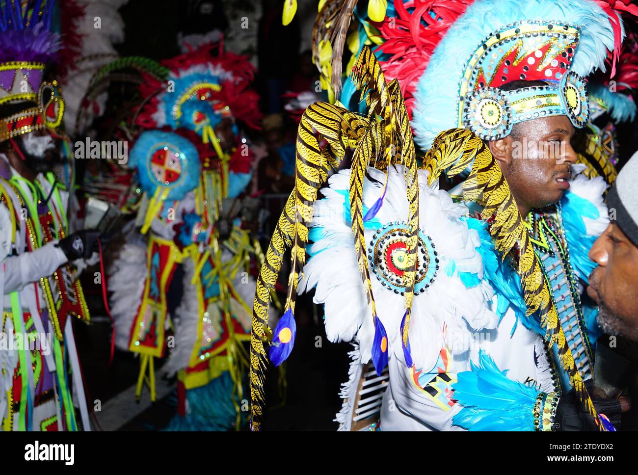 People celebrating in colorful costumes and dancing to music at the ...