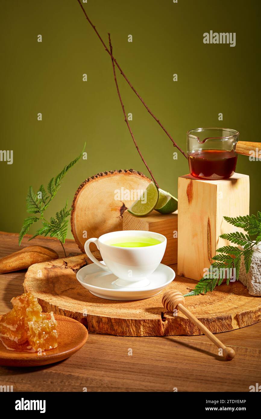 A cup of tea is placed in the center on a log, surrounded by ...