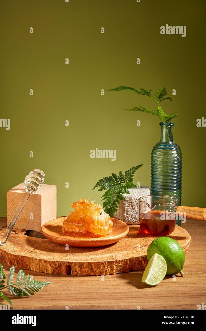 Natural raw beeswax on wooden plate, honey in beaker, surrounded by ...