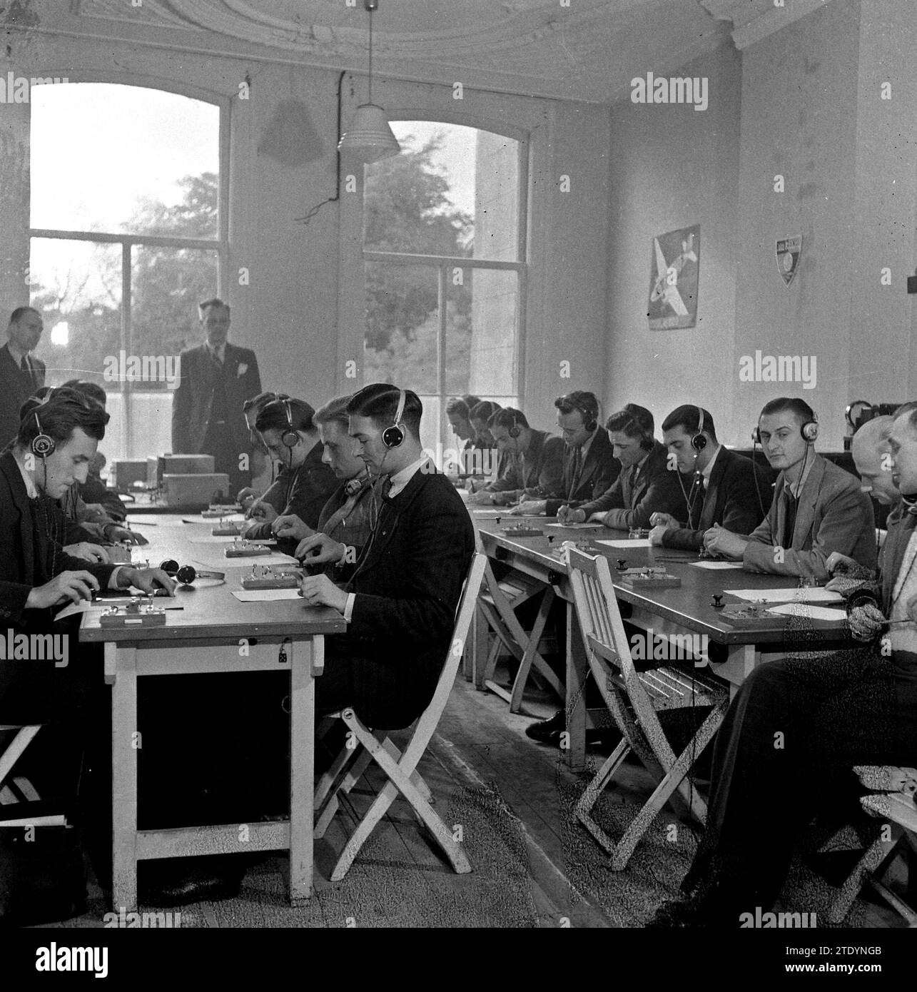 Men training on telegraph keys for World War II telegraph operator work ...