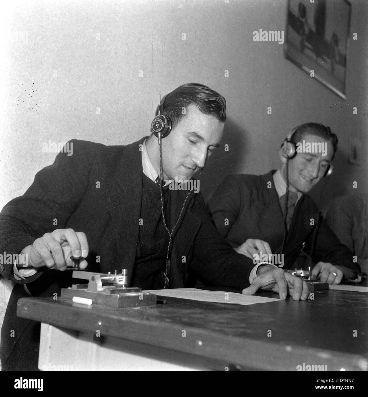 Men training on telegraph keys for World War II telegraph operator work ...