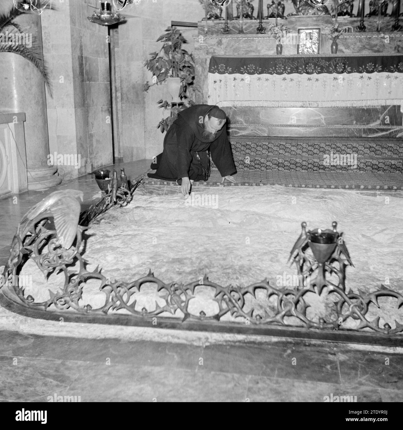 Monk at the 'stone' in front of the altar of the Church of the agony ...