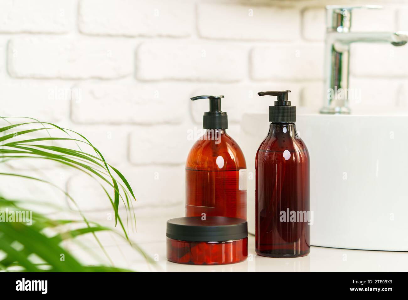 Soap and cream dispenser jars near the sink in a bathroom Stock Photo ...