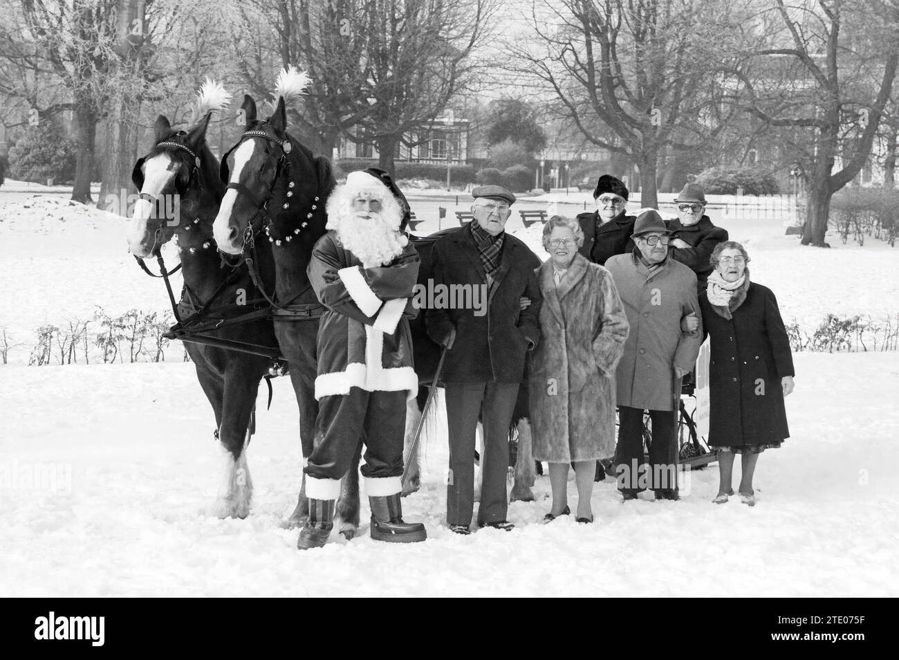 Three sixty-year-old couples with sleigh and Santa Claus, Christmas and ...