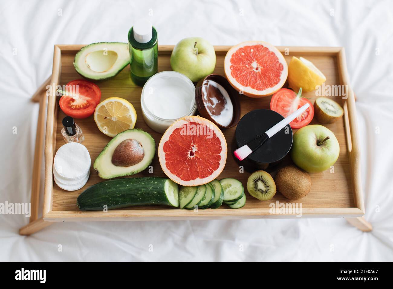 Wooden bed tray with fresh fruits and face skin care products Stock ...