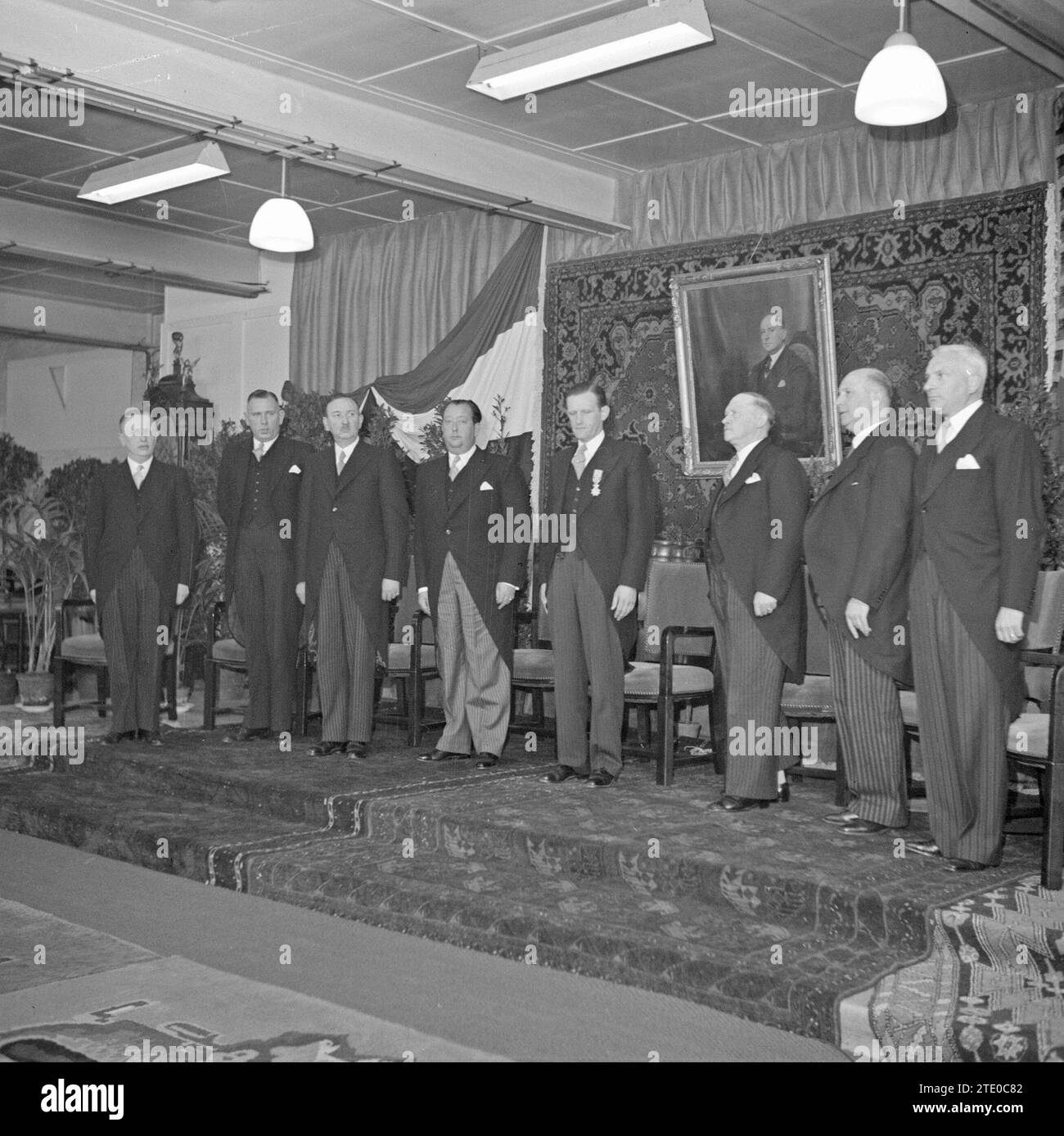 Men in morning coats on stage, 4th and 5th from the left respectively ...