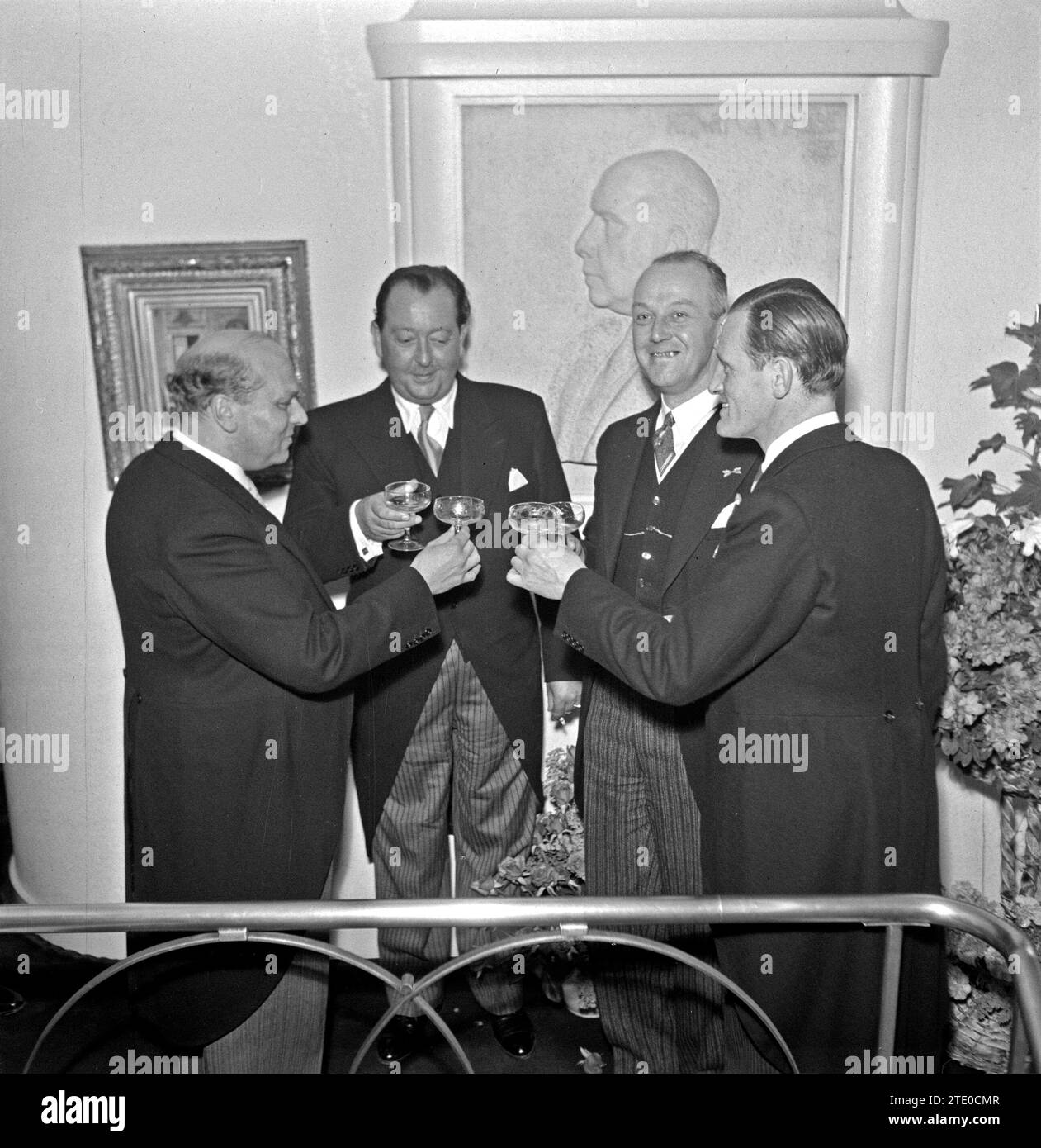 Factory directors Jan (2nd left) and Albert van Abbe (far right) toast ...