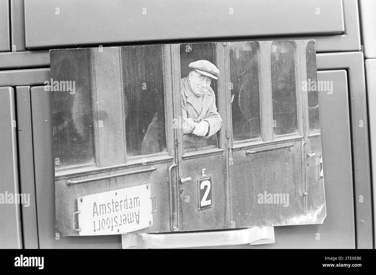 Photo of a photo of a smoking man hanging out of the compartment of a ...