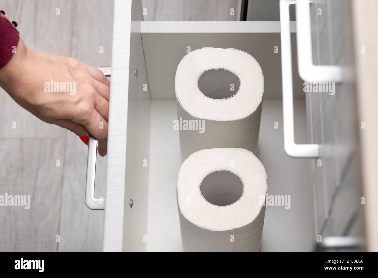 Woman taking towel from storage hi-res stock photography and images - Alamy
