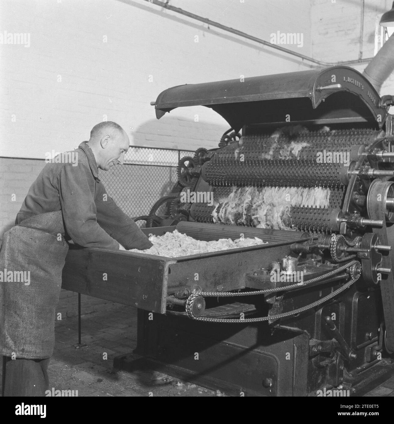 Man at work in a leather and textile manufacturing factory ca. 1945 ...