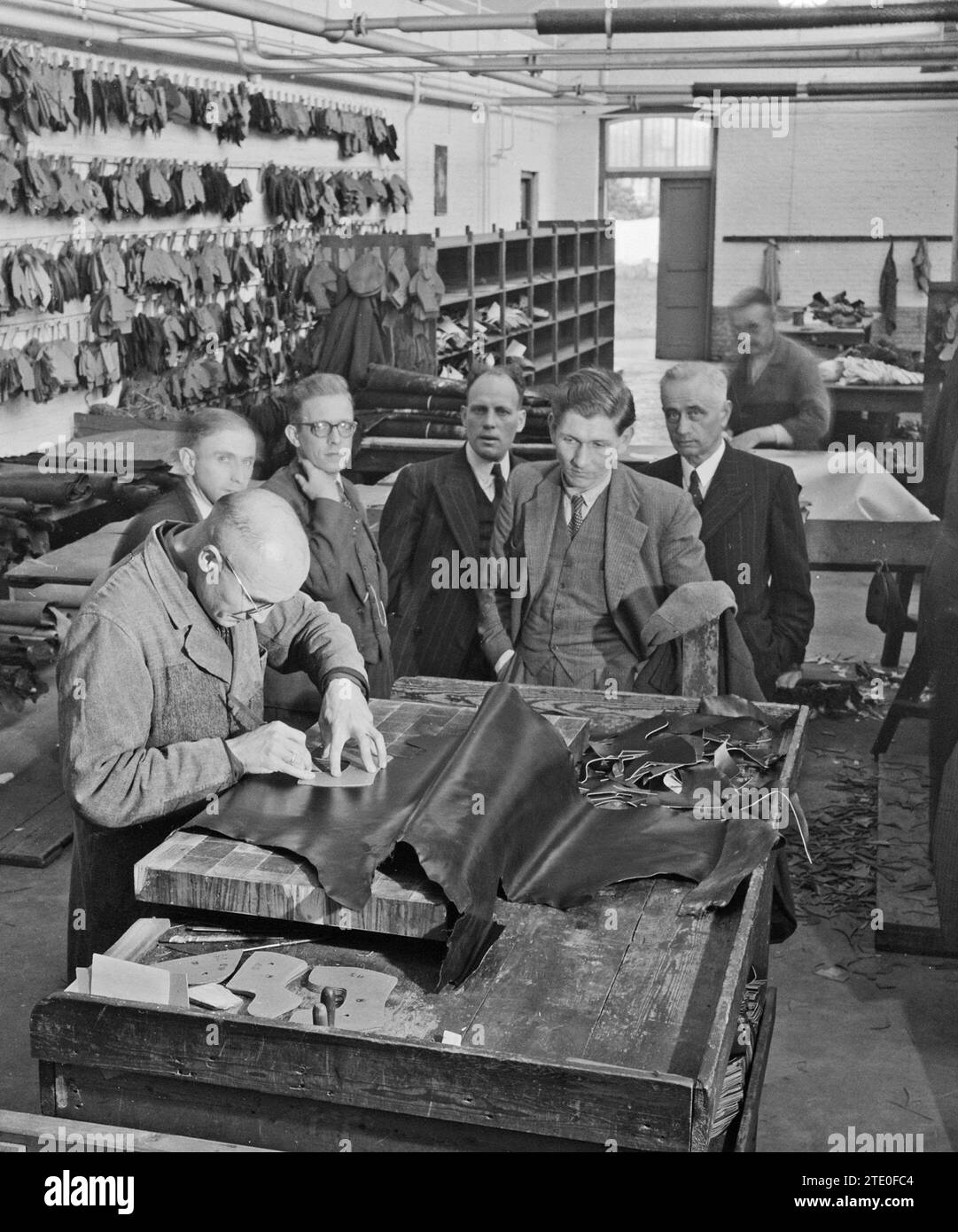 Man at work in a leather and textile manufacturing factory ca. 1945 ...