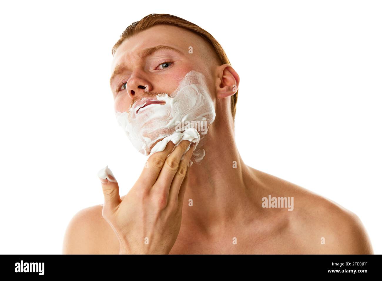 Hygiene treatments. Attractive man applying shaving foam looking at camera against white studio ...