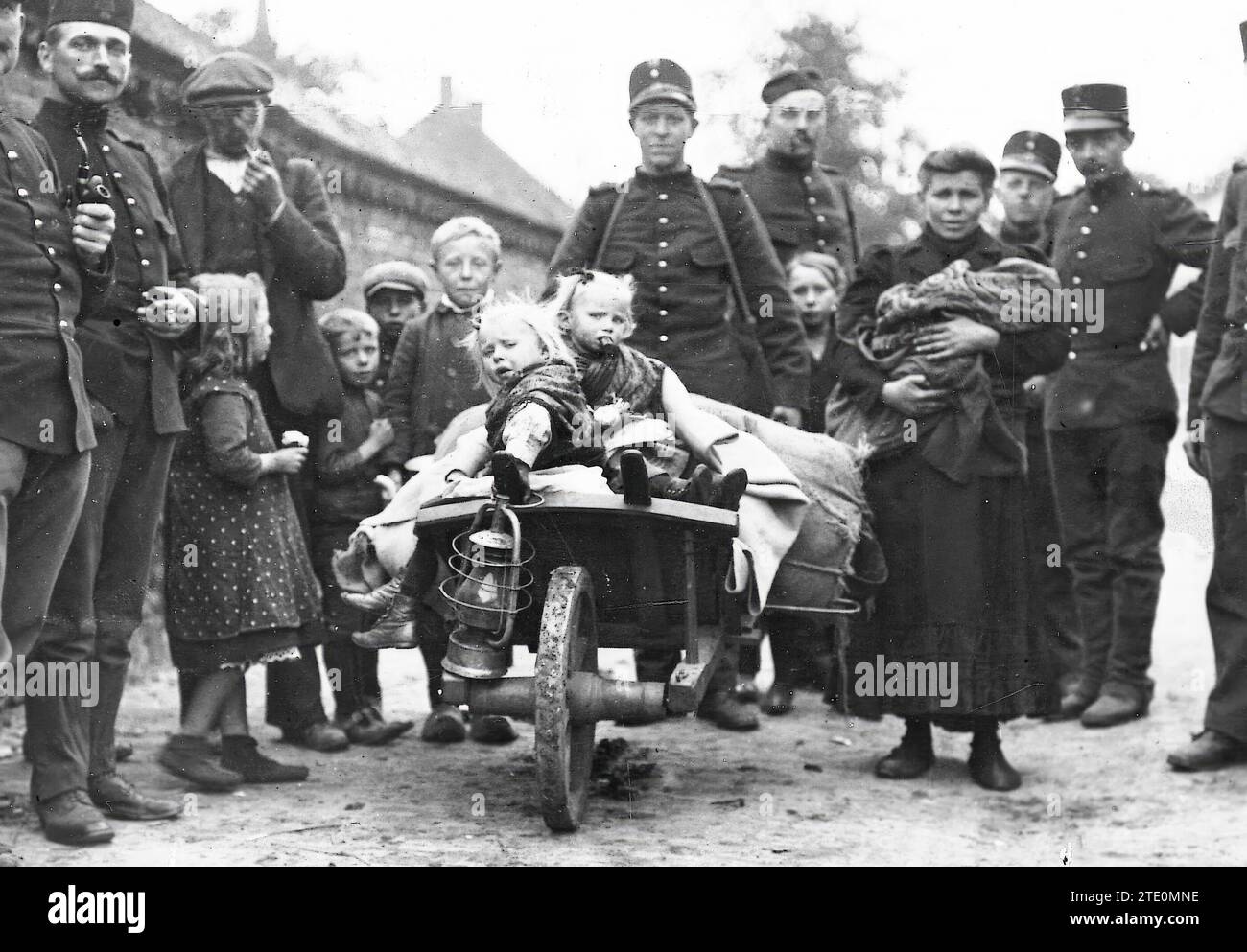 Holland, October 1914. Dutch soldiers helping several Belgian children ...