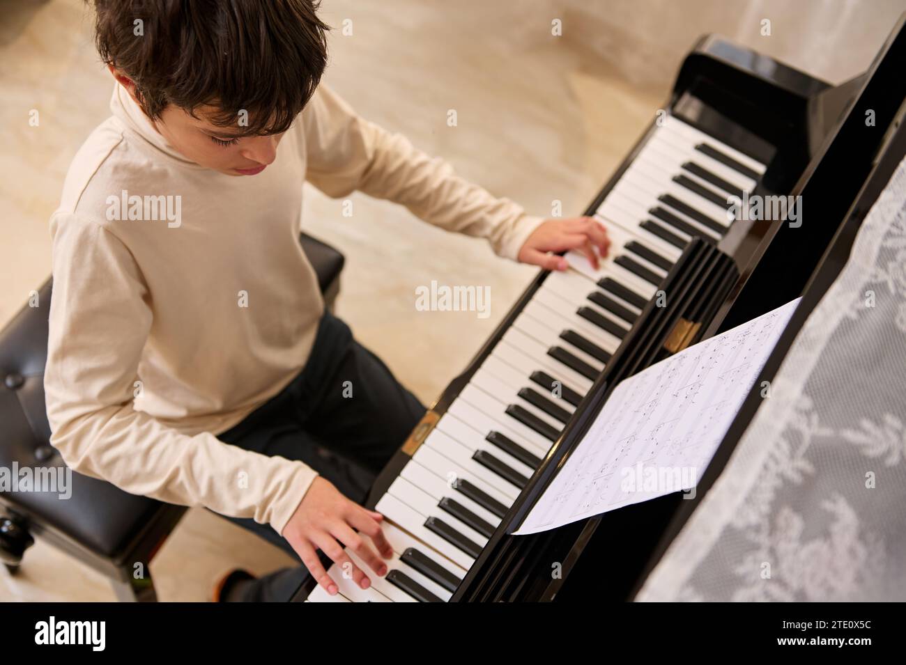 View from above multi ethnic handsome talented teenage boy, pianist ...