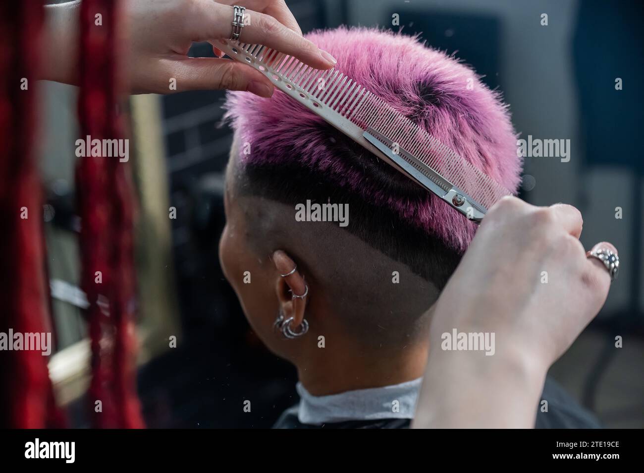 Asian woman with pink hair getting a haircut in a barbershop Stock ...
