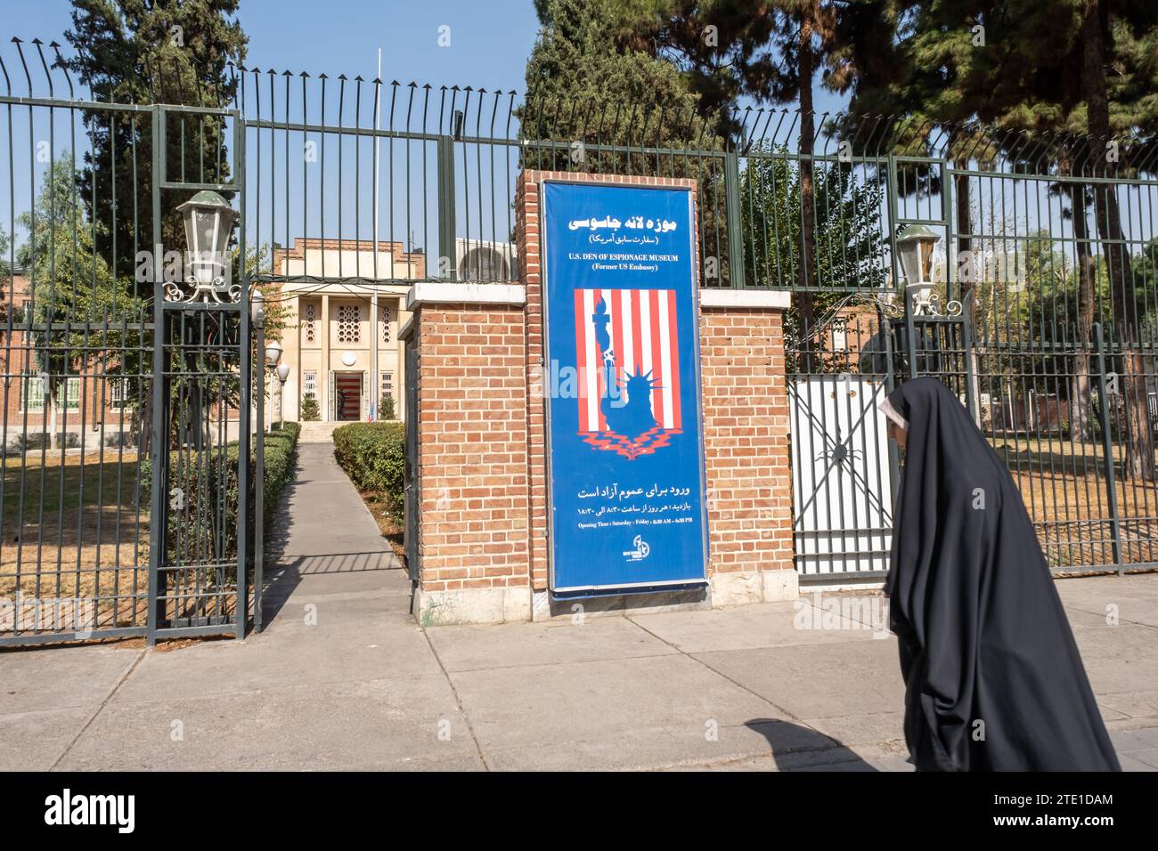Woman in hijab walking near main entrance to the former US Embassy in ...