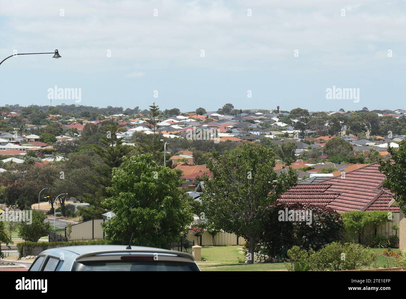 General view of the rooftop houses and green trees and shrubs of an ...