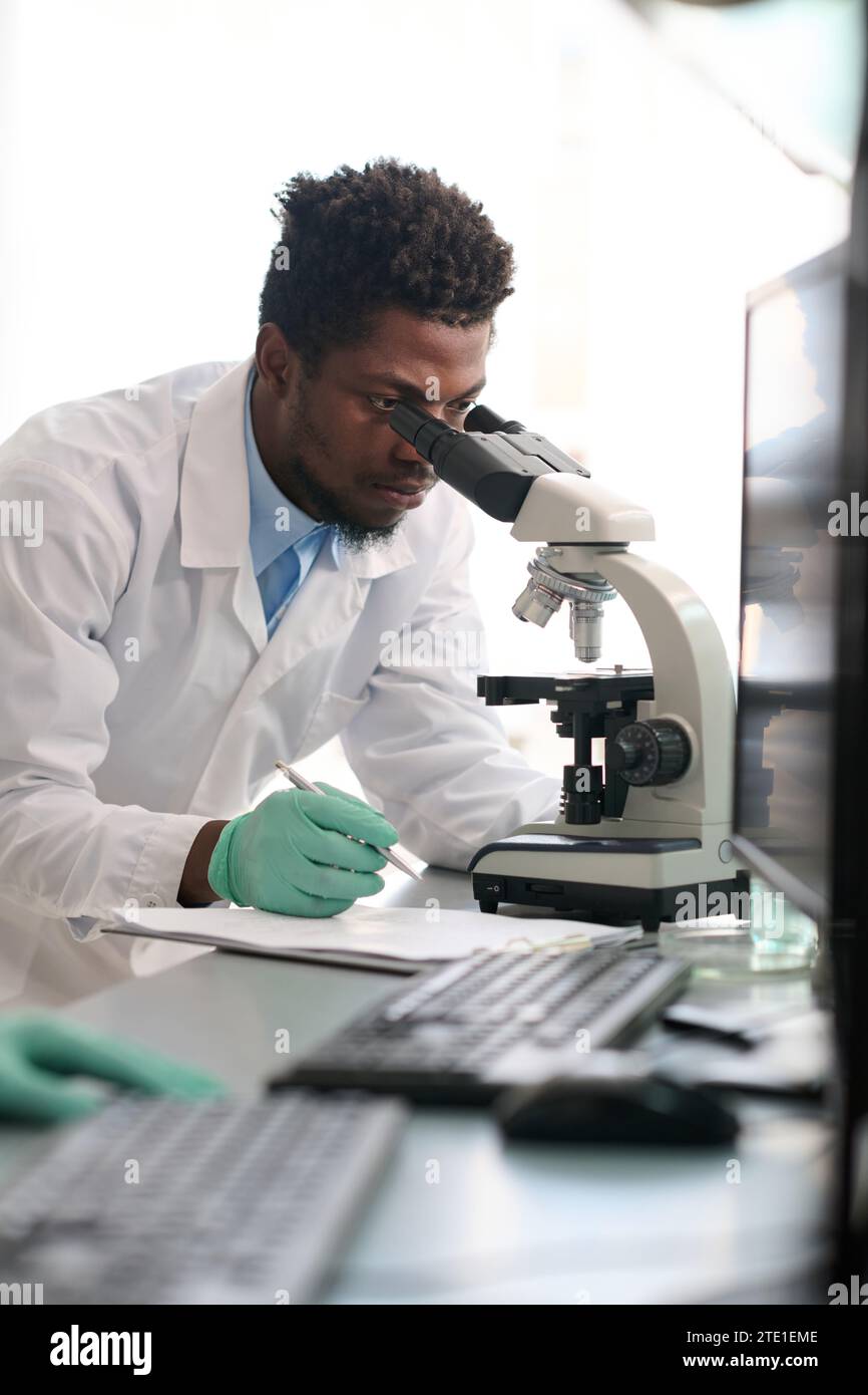 Laboratory Professional Using Microscope Stock Photo - Alamy