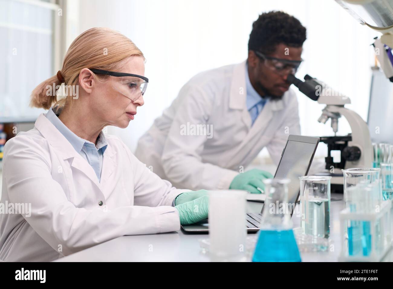 Two Scientists Working in Laboratory Stock Photo - Alamy