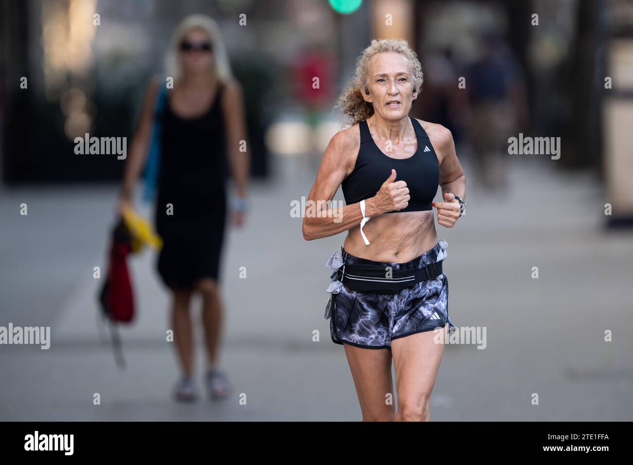 Older woman running through the streets of Budapest Stock Photo - Alamy