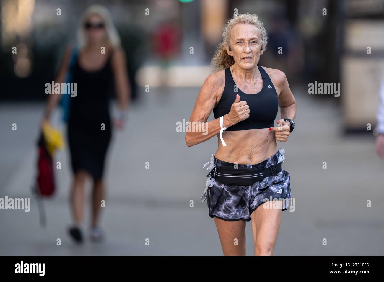 Older woman running through the streets of Budapest Stock Photo - Alamy