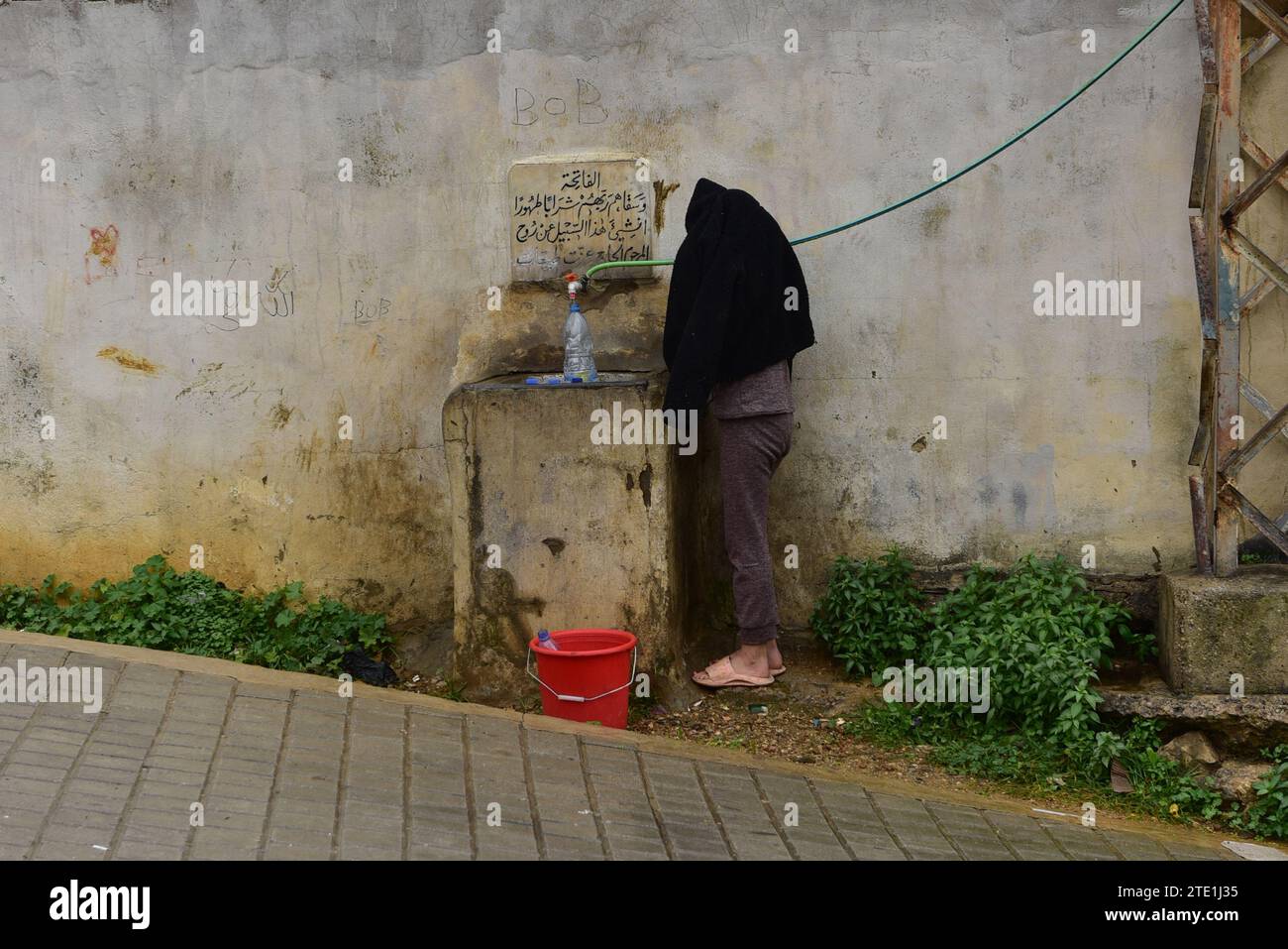 Local woman getting water from a public tap on El Amir Fakhreddine ...