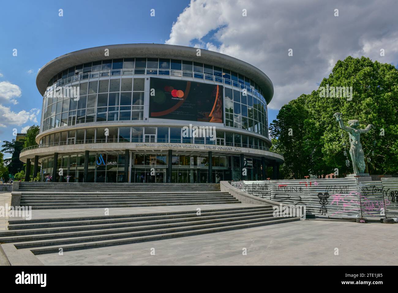 Tbilisi Concert Hall, a round glass building completed in 1971. Statue ...