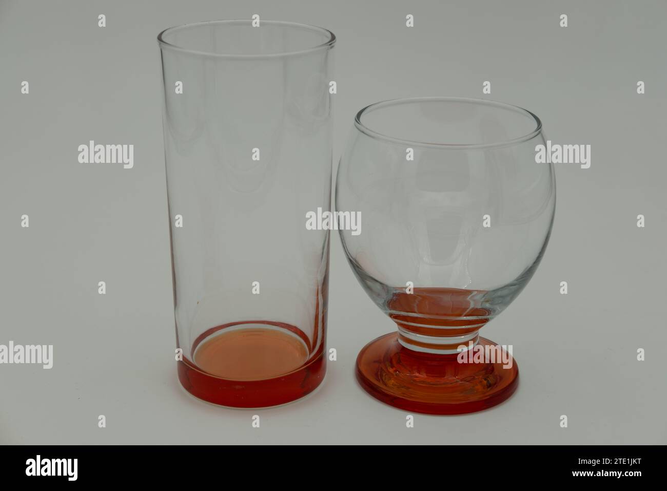 Orange colored glass on a white background Stock Photo - Alamy
