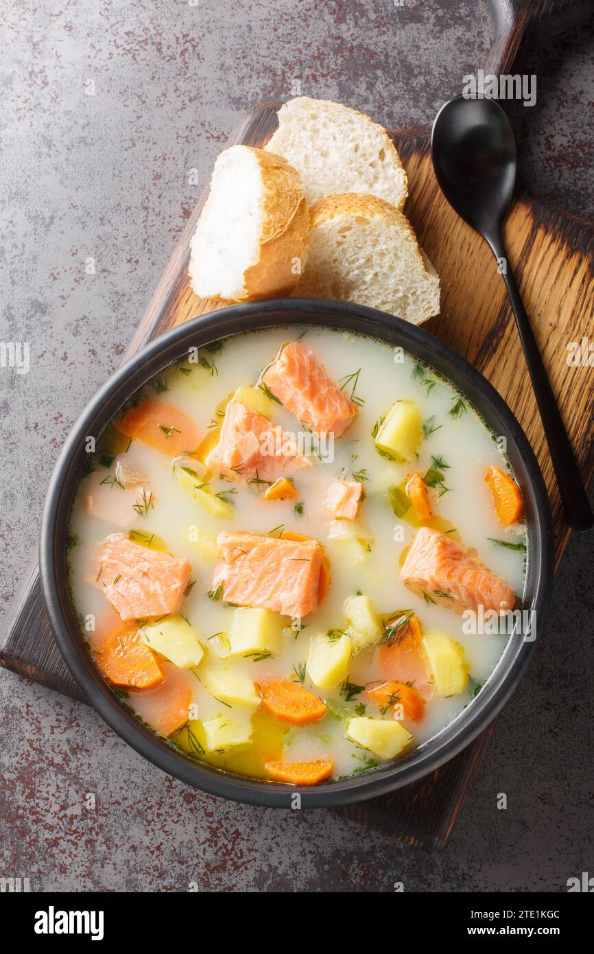 Homemade creamy red fish soup with vegetables and dill on a plate ...