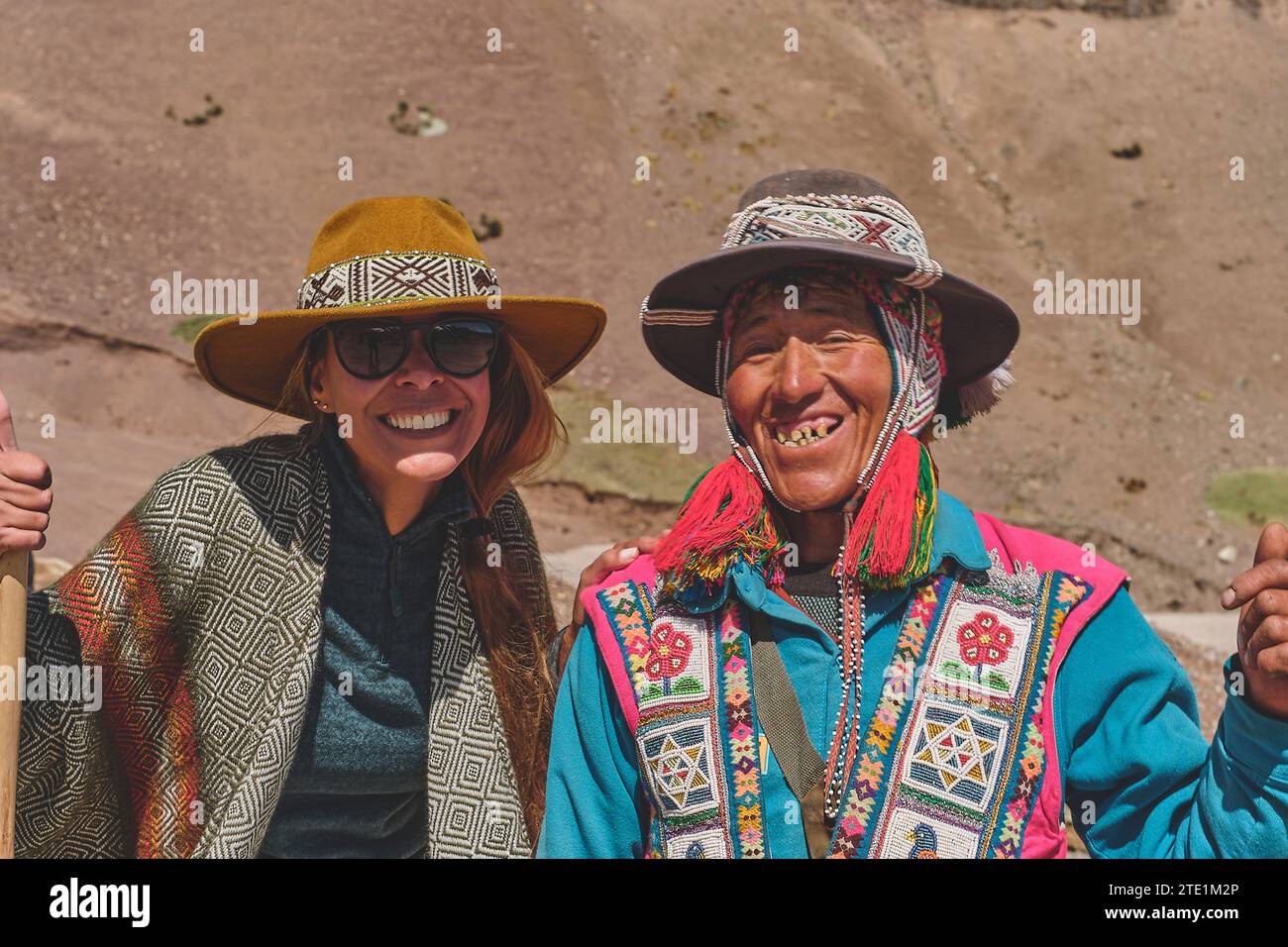 Happy native peruvian man with young tourist with typical colorful at ...