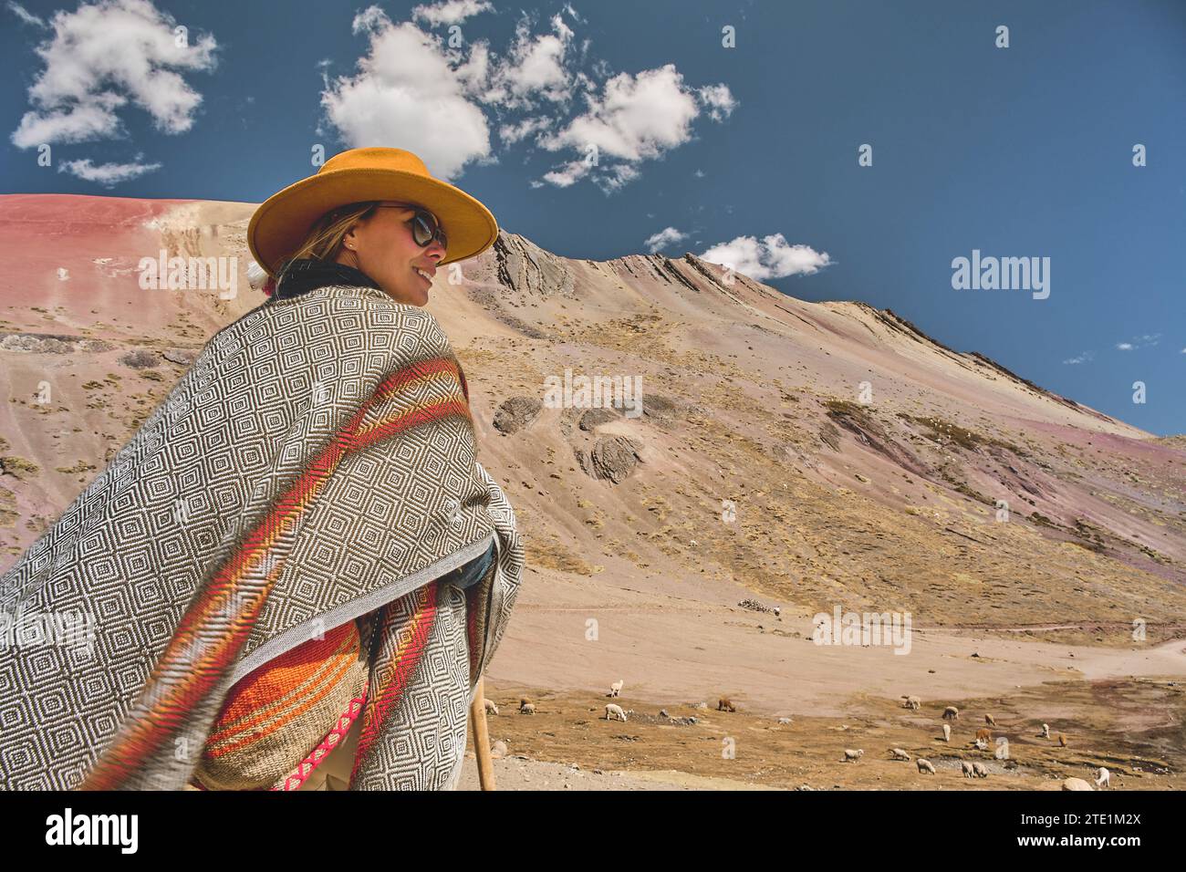 Woman standing on the mountain of the Peruvian Andes with the entire ...
