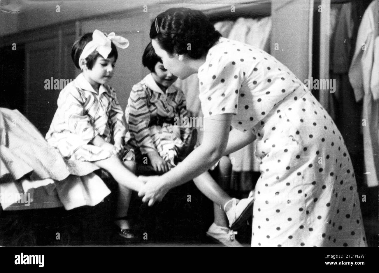 09/30/1936. Woman Helping Two Girls Change Their Clothes for Cleaner ...