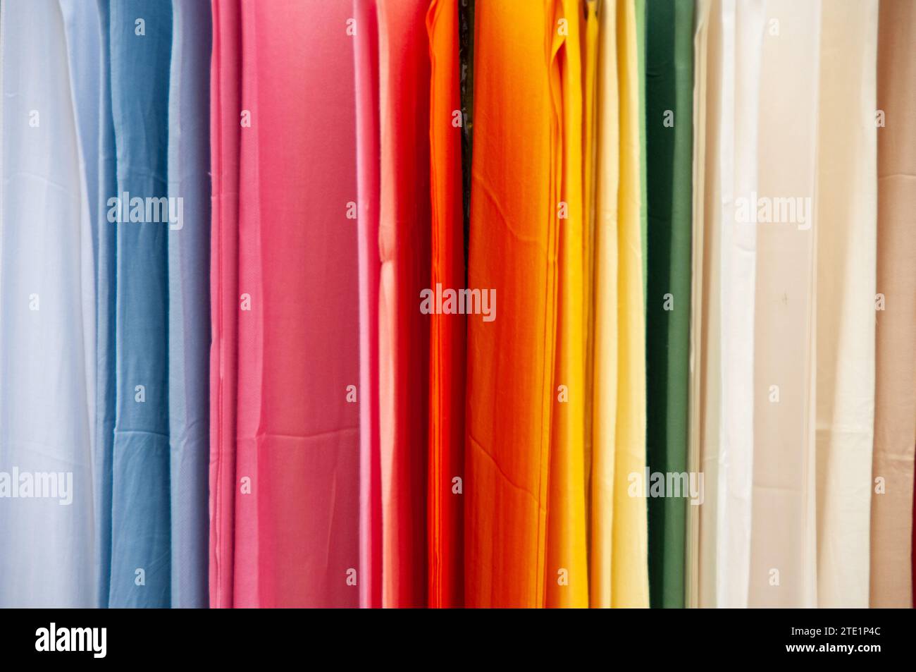Abstract detail of rows of soft, cotton fabric bolts forming a rainbow ...