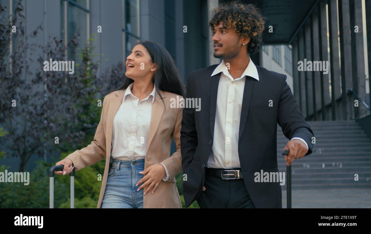 Two diverse multiracial people partners coworkers walking together ...