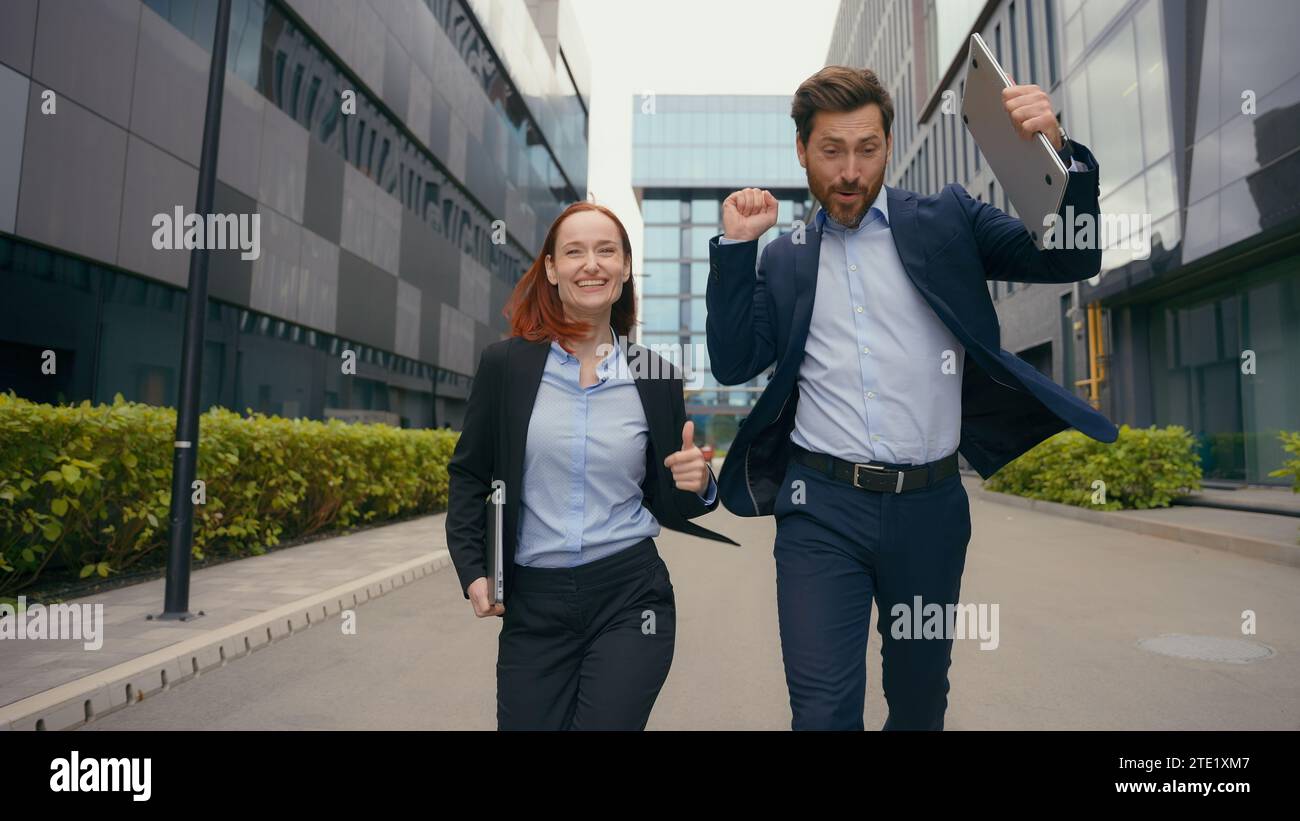 Happy business people colleagues running in city office freedom wow ...