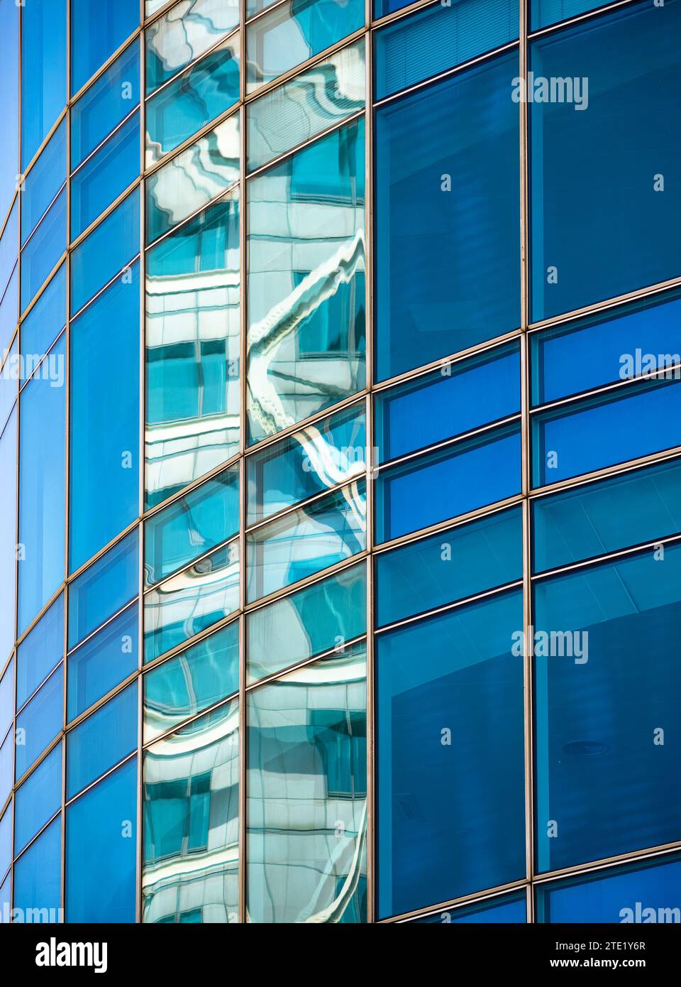 Part of a blue colored facade of a skyscraper glass building in ...