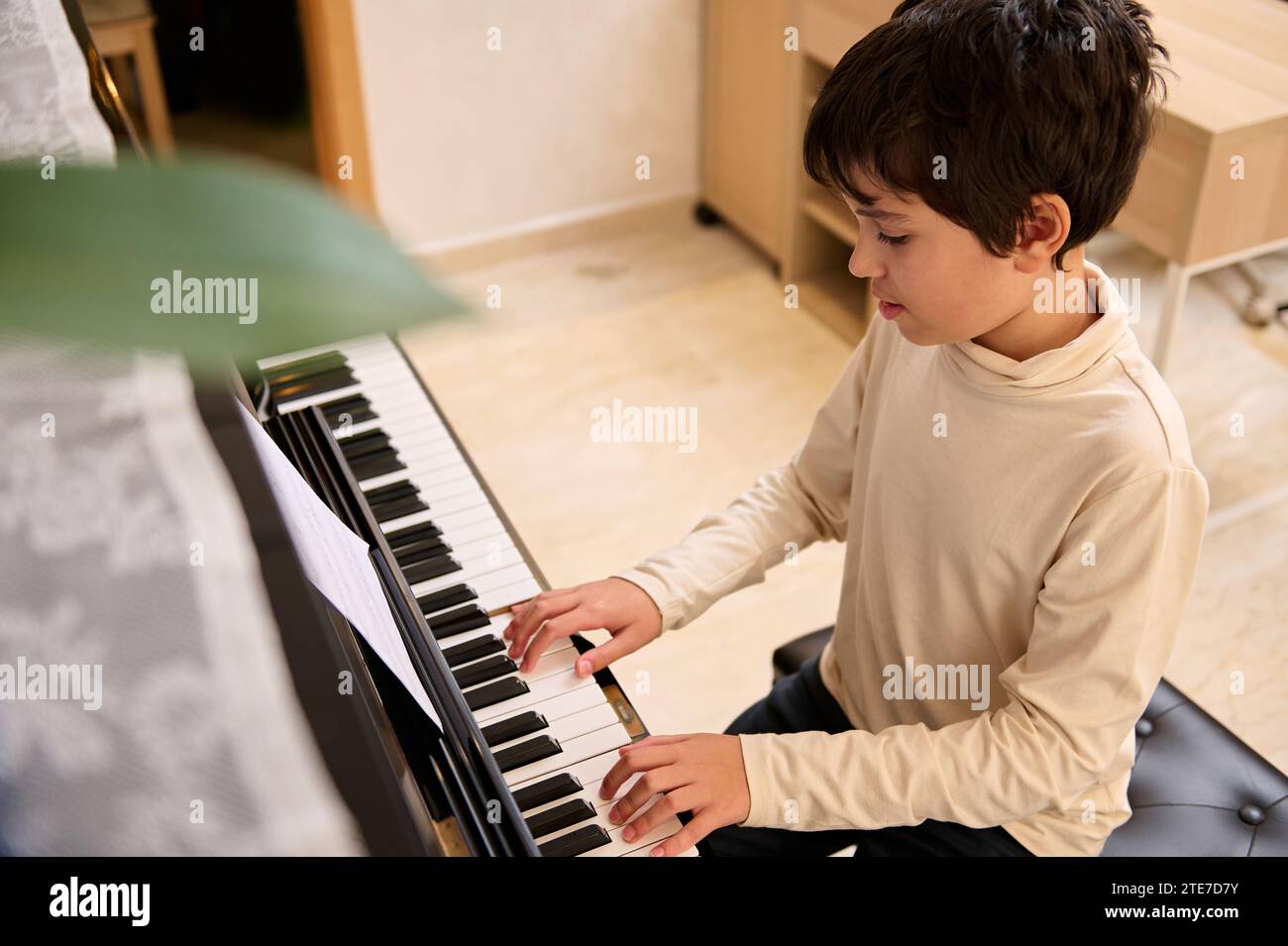 Hispanic teen learning piano hi-res stock photography and images - Alamy