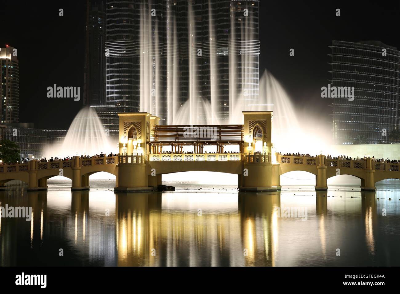 Dubai Fountain bridge near Burj Khalifa at night. Dancing fountain ...