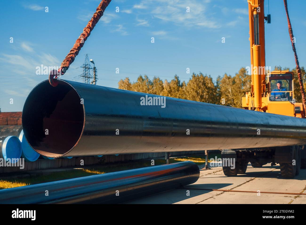 Shipment of new large diameter metal pipes on summer day from open ...