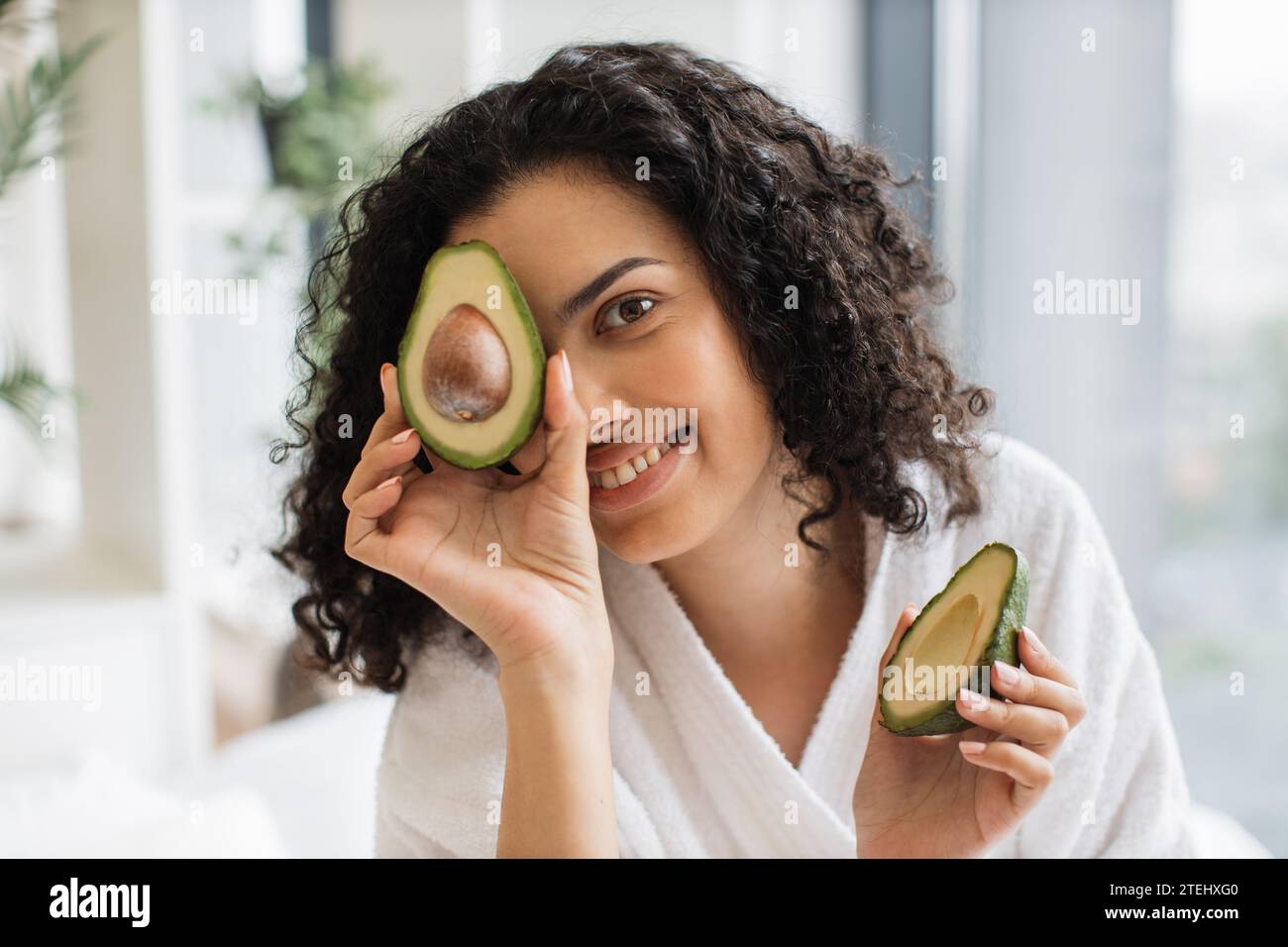 African american woman holding avocado hi-res stock photography and ...