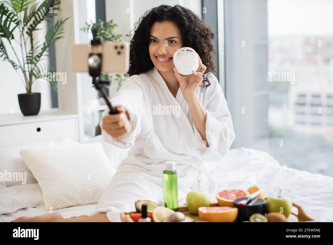 Beautiful young African woman social media influencer in bathrobe ...