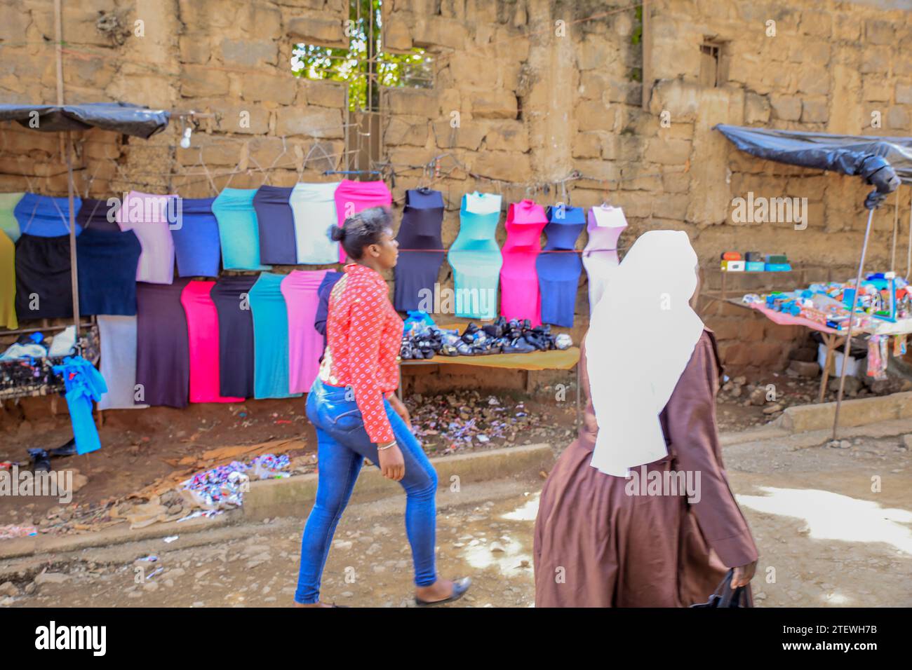 Hawkers sell second hand clothes by the streets in Kibera Slum, Nairobi ...